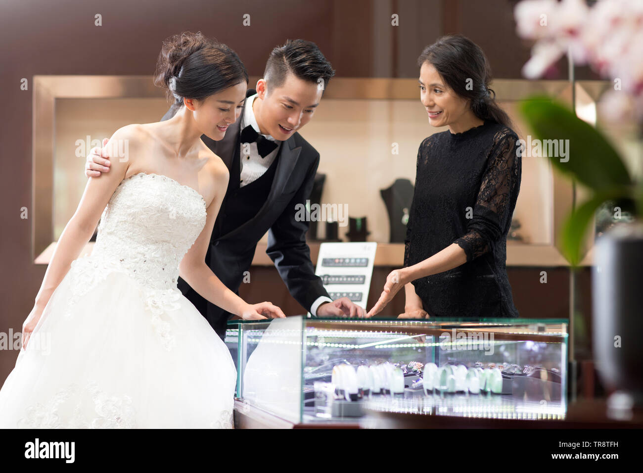 Happy bride and groom shopping in jewelry store Stock Photo - Alamy
