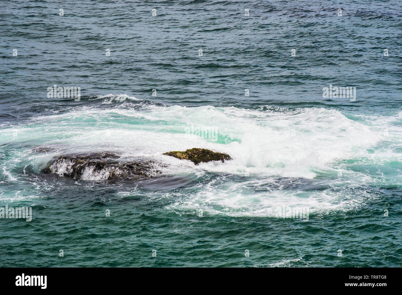 Rocks in the ocean Stock Photo - Alamy