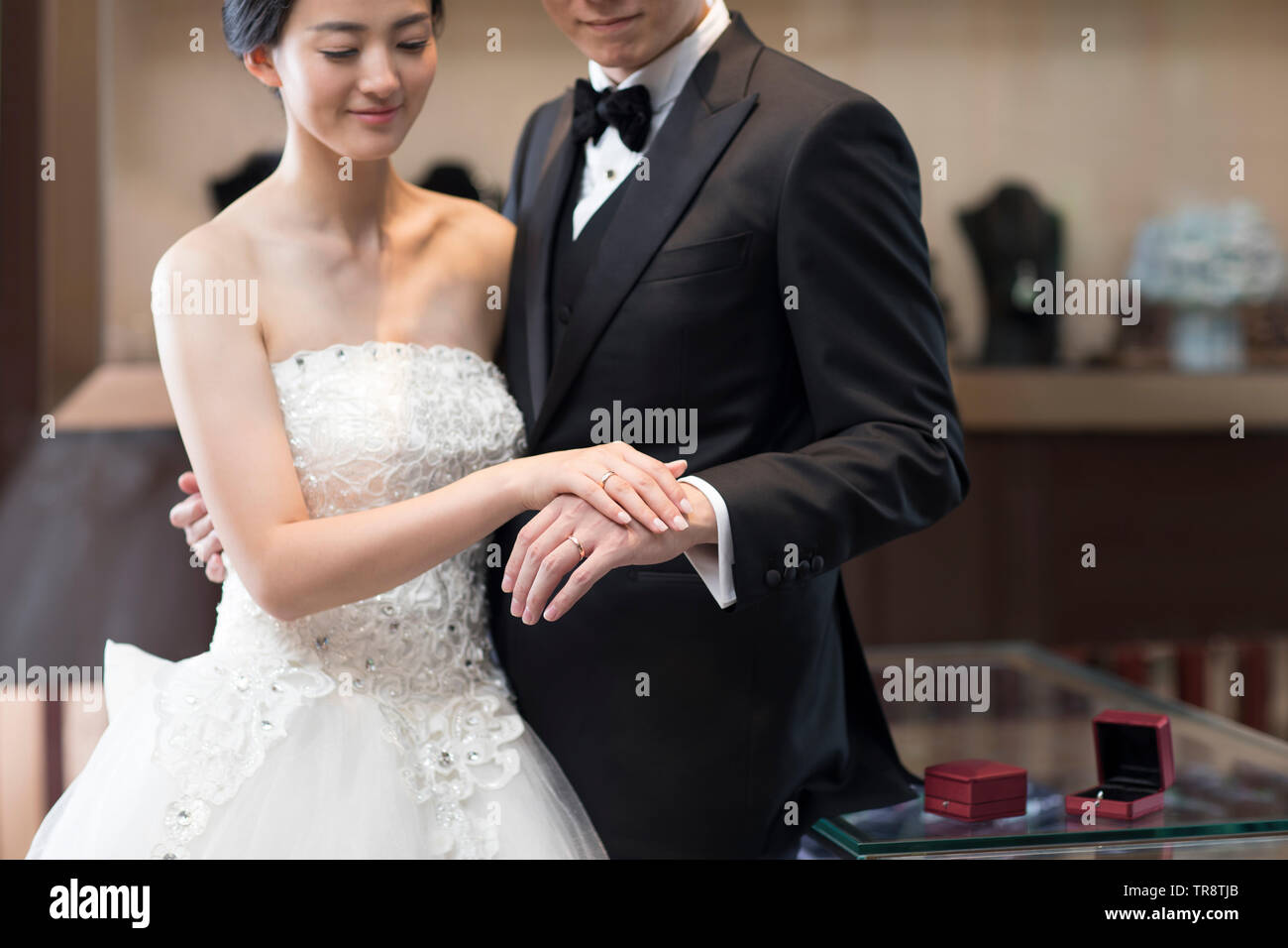 Happy bride and groom shopping in jewelry store Stock Photo - Alamy