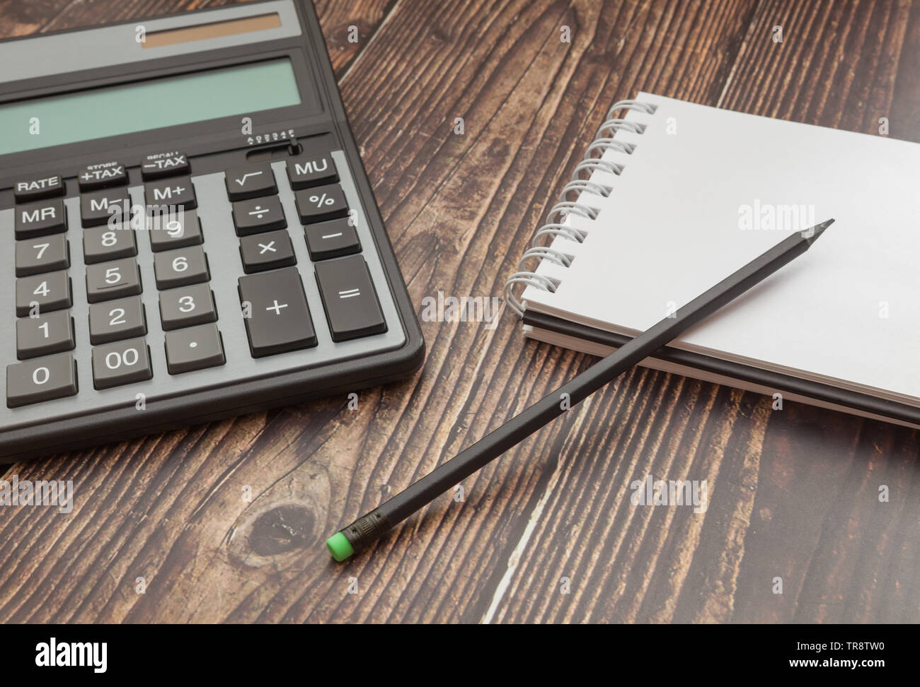 Notebook and calculator on wooden background, business concept Stock ...