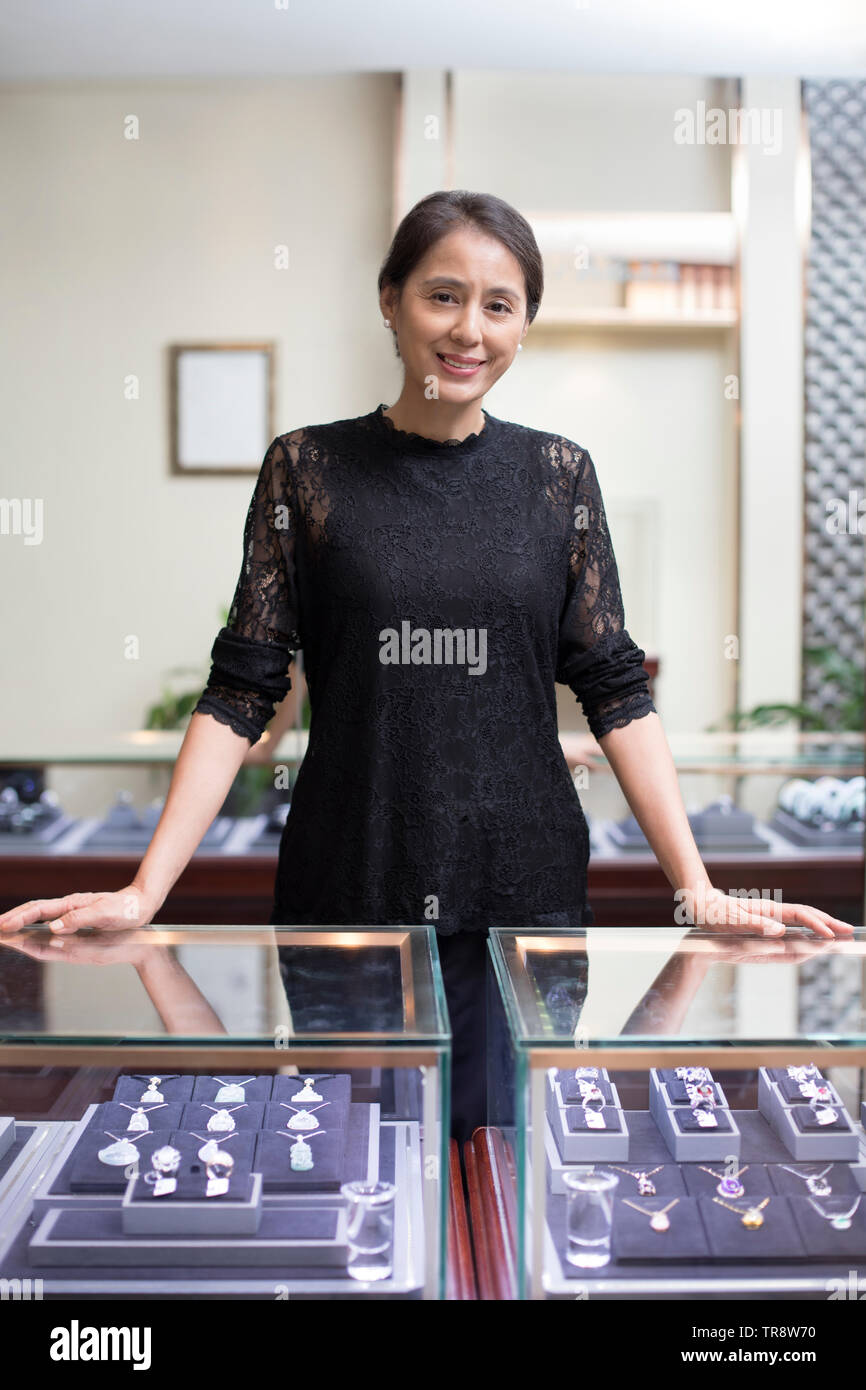 Elegant shopkeeper in jewelry store Stock Photo - Alamy