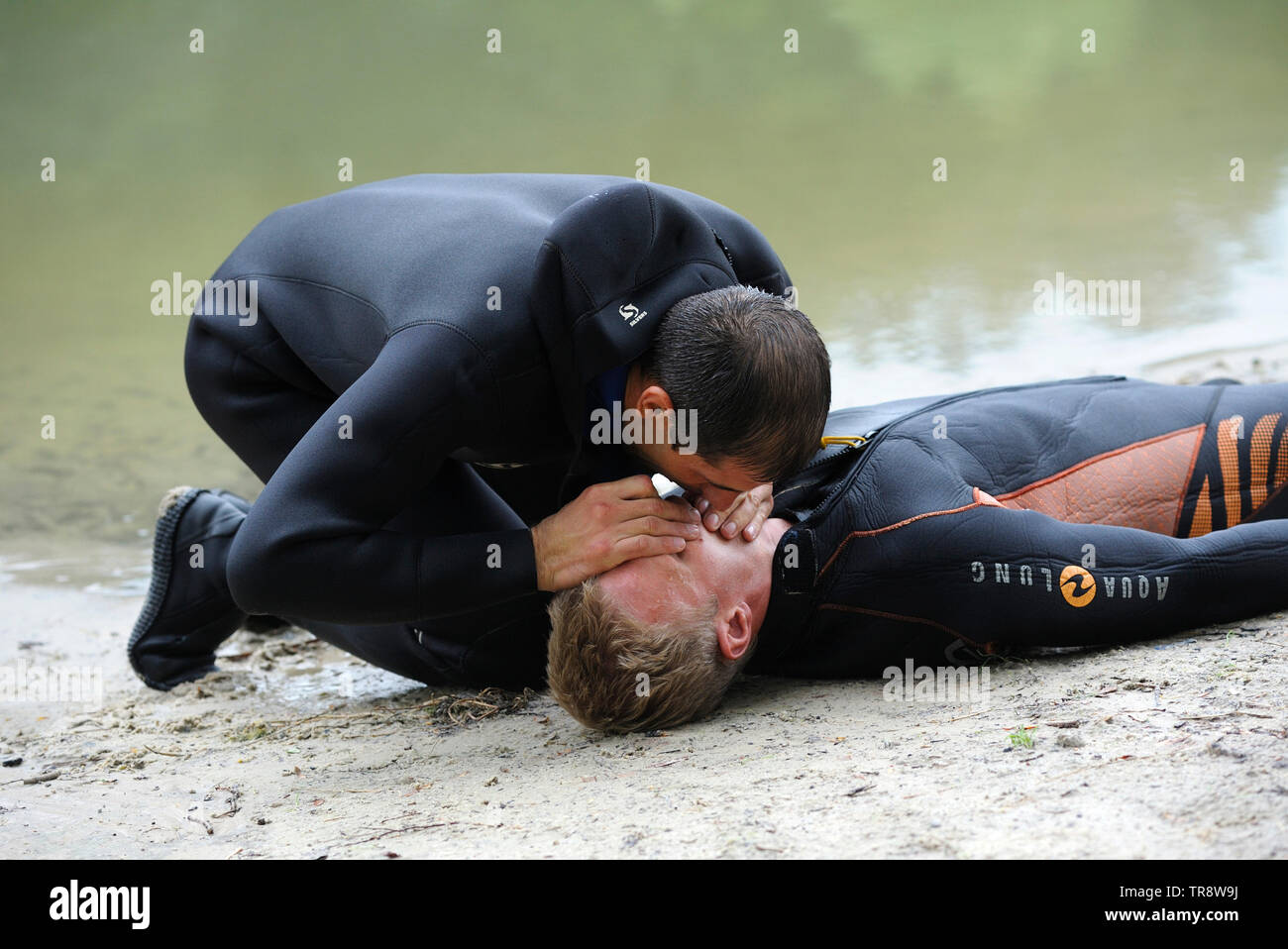 Lesson of artificial respiration. Lifeguard giving drowning mouth-to ...