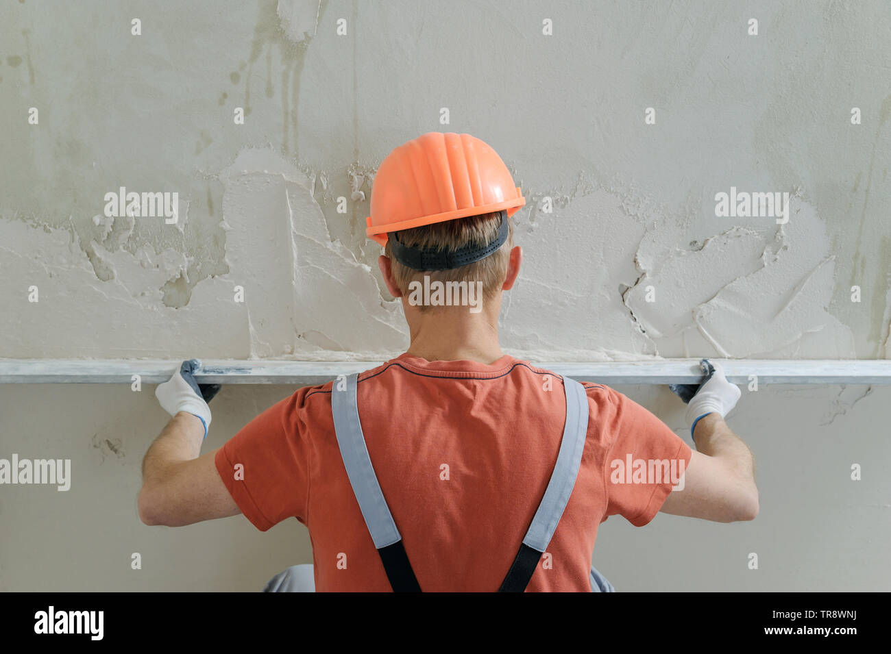 Construction working putting plaster hi-res stock photography and ...