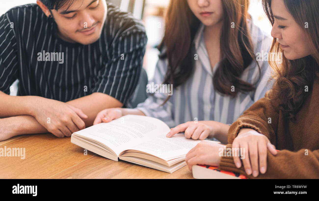Group of young people enjoyed reading the same book together Stock ...