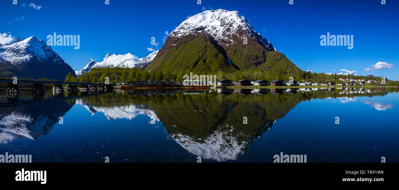 Beautiful reflections in Rauma river of mountains and blue sky. View ...