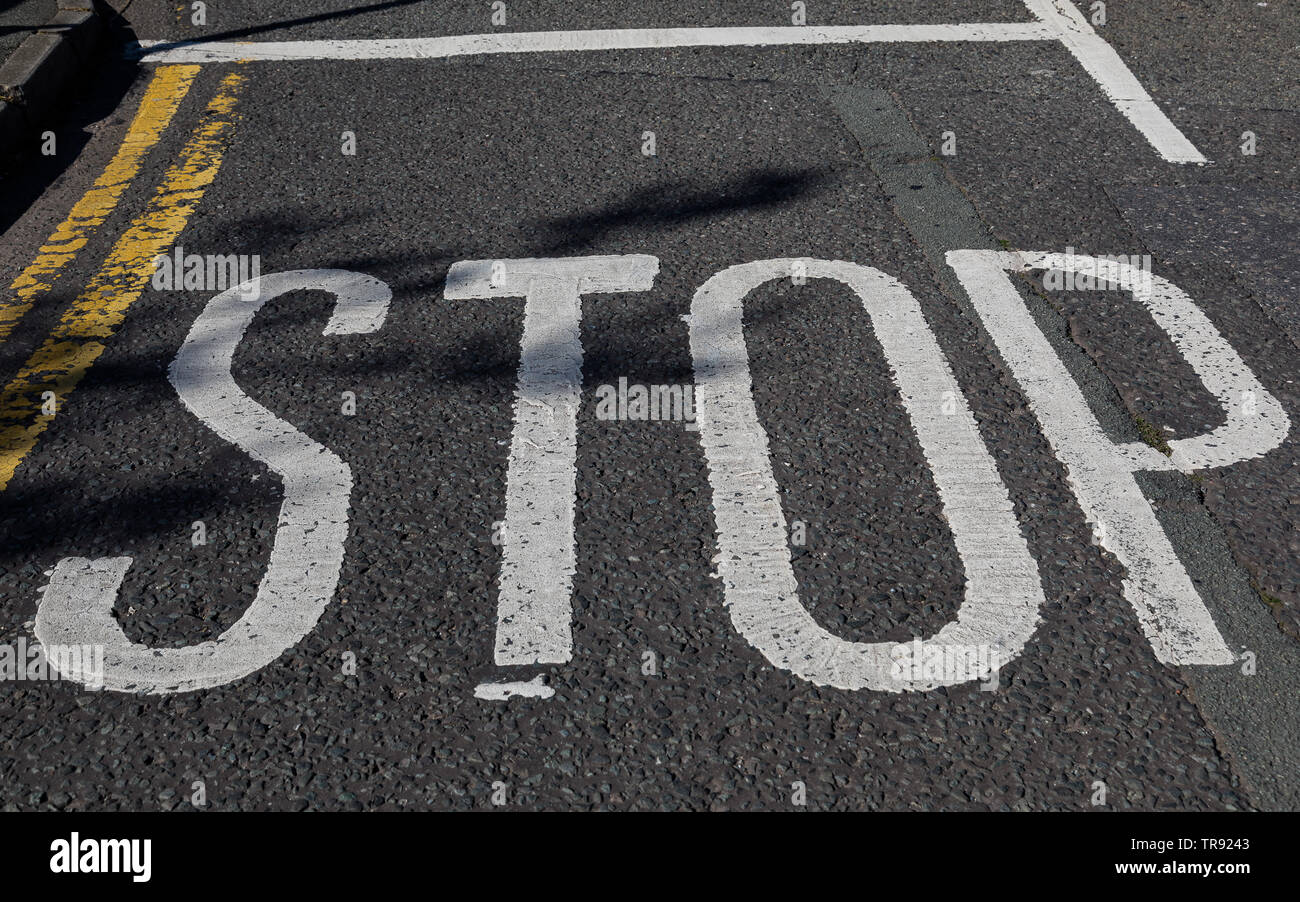 Stop markings painted white on a tarmac road birkenhead wirral april ...