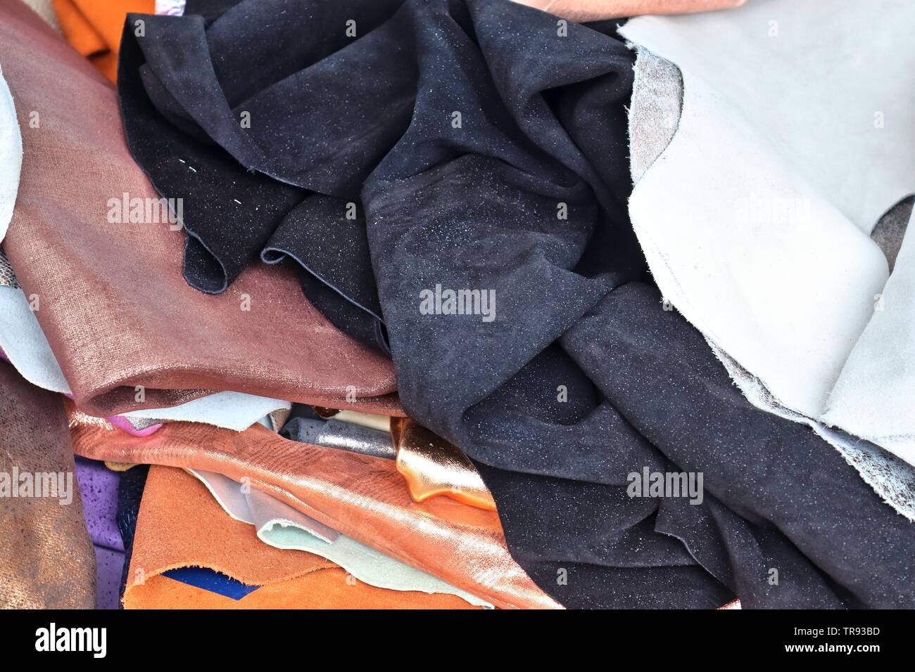 Close up surface of colorful fabrics cloth and textiles being folded ...