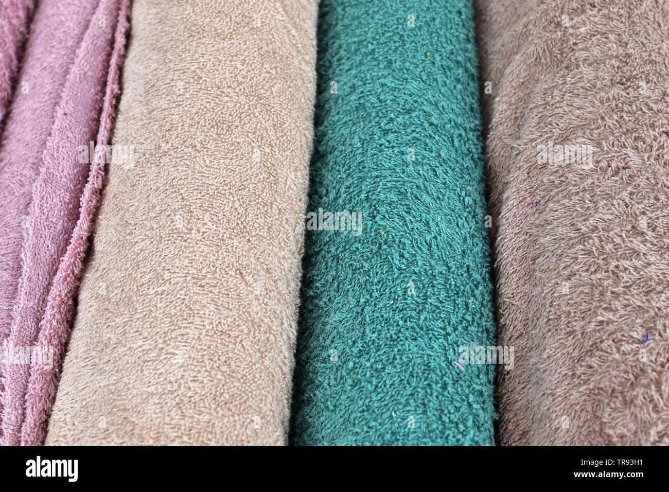 Close up surface of colorful fabrics cloth and textiles being folded ...