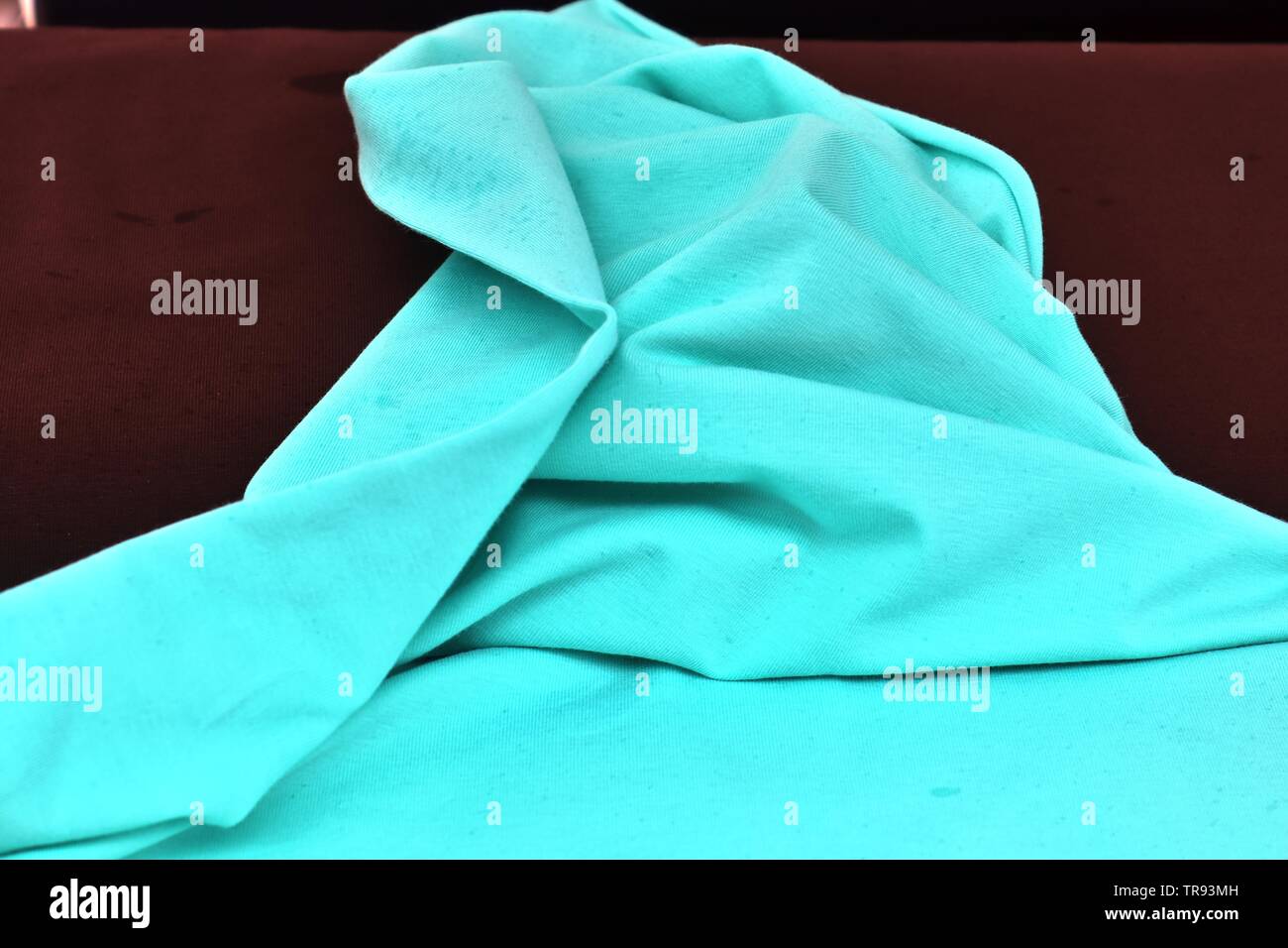 Close up surface of colorful fabrics cloth and textiles being folded ...