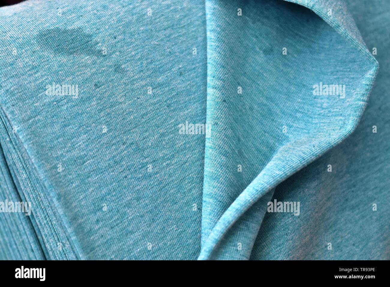 Close up surface of colorful fabrics cloth and textiles being folded ...