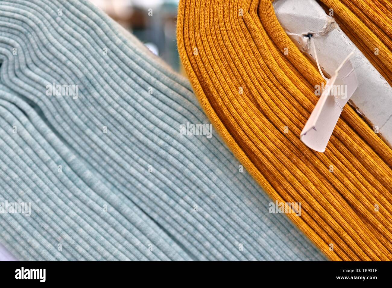 Close up surface of colorful fabrics cloth and textiles being folded ...