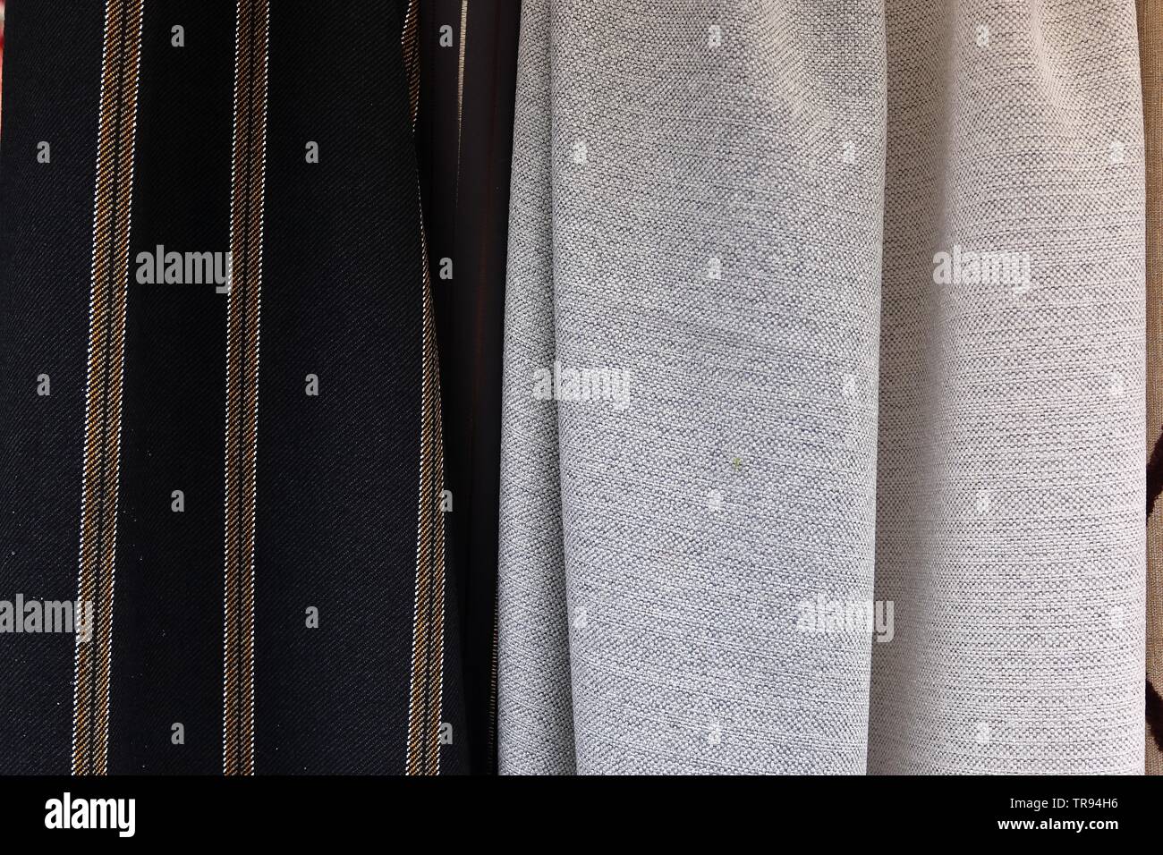 Close up surface of colorful fabrics cloth and textiles being folded ...