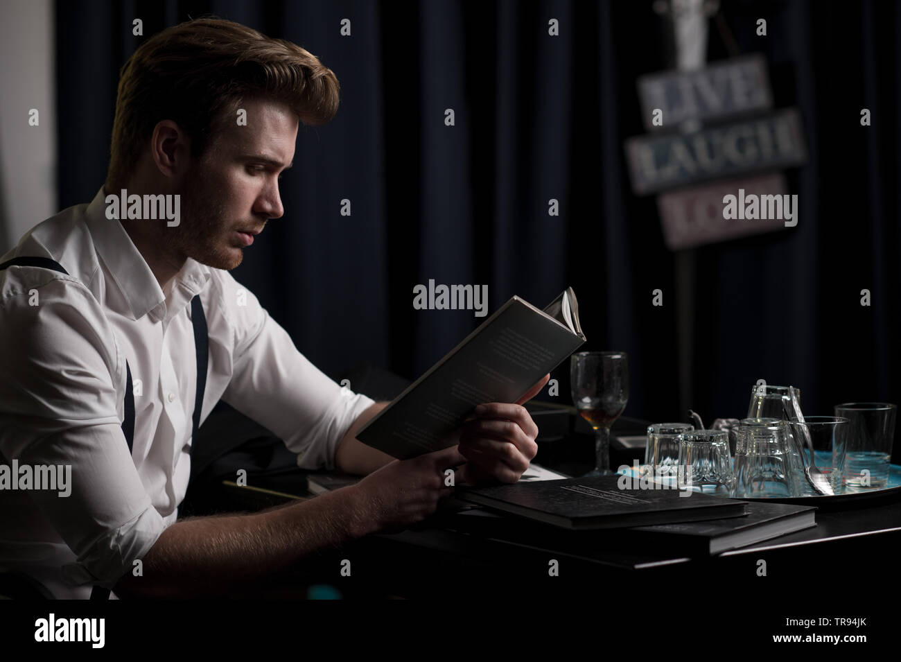 Man wine glass reading book hi-res stock photography and images - Alamy