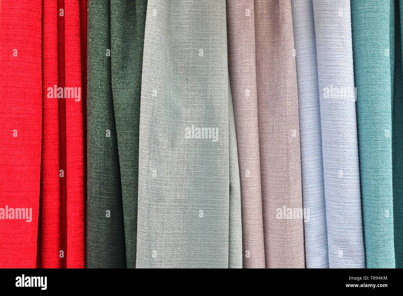 Close up surface of colorful fabrics cloth and textiles being folded ...