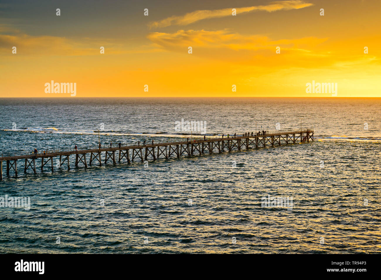 Port Noarlunga jetty with fishermen at sunset, South Australia Stock ...