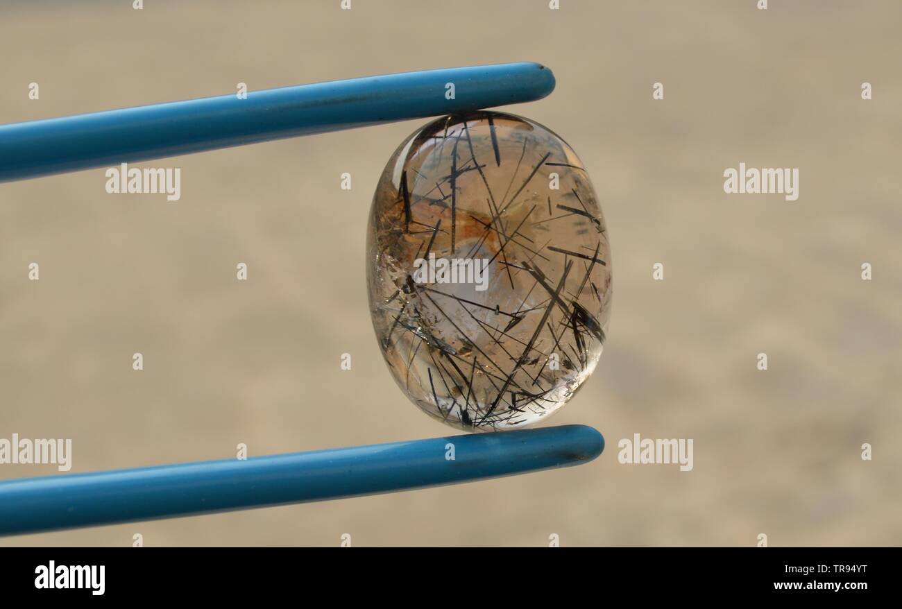 Rutilated Quartz black needles and copperi red hematite inclusion Stock ...