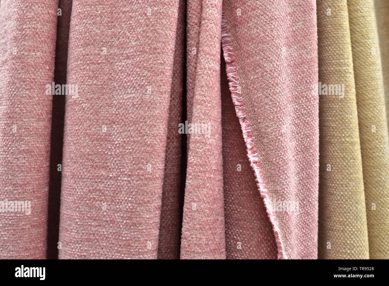 Close up surface of colorful fabrics cloth and textiles being folded ...