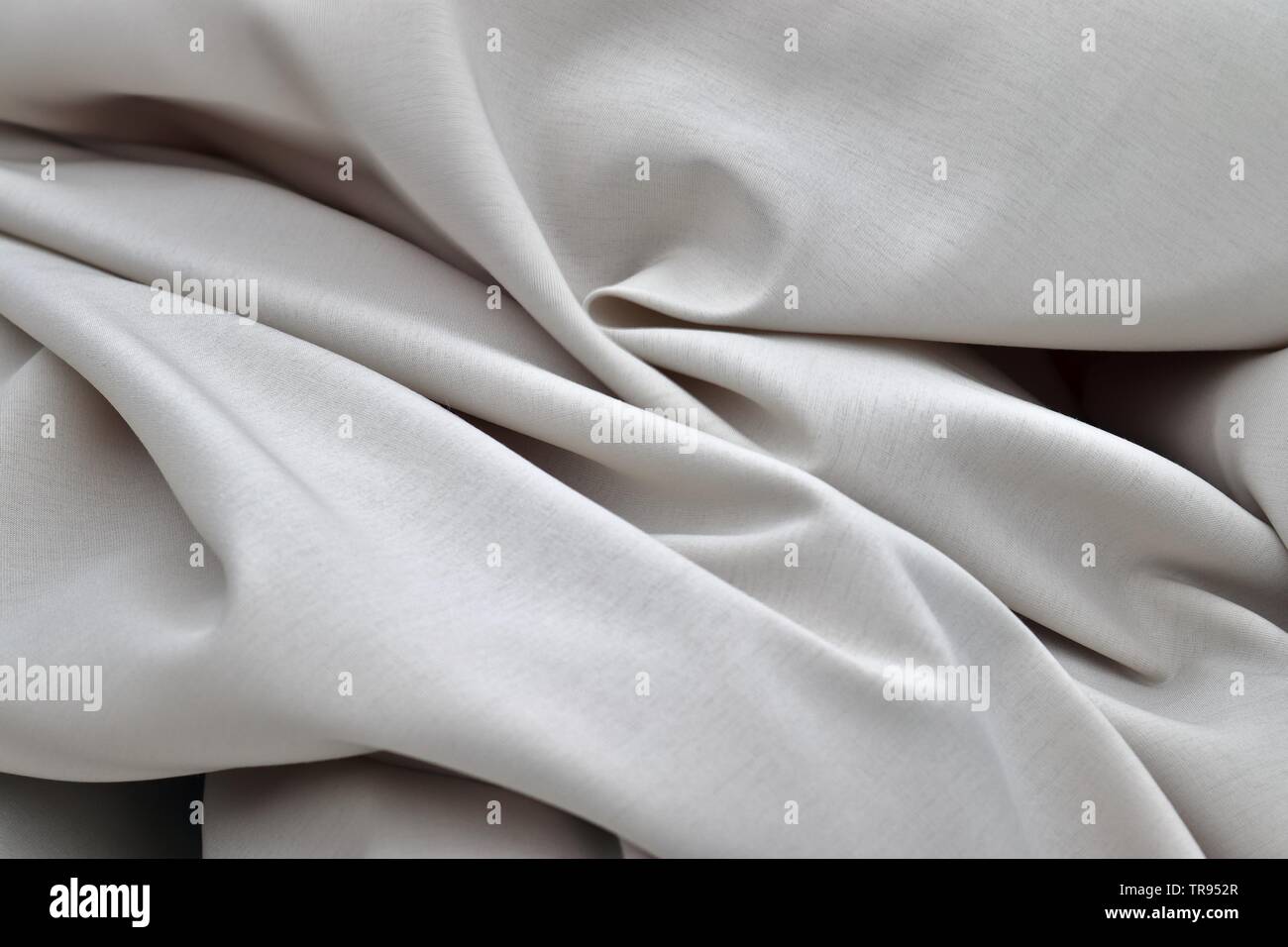 Close up surface of colorful fabrics cloth and textiles being folded ...