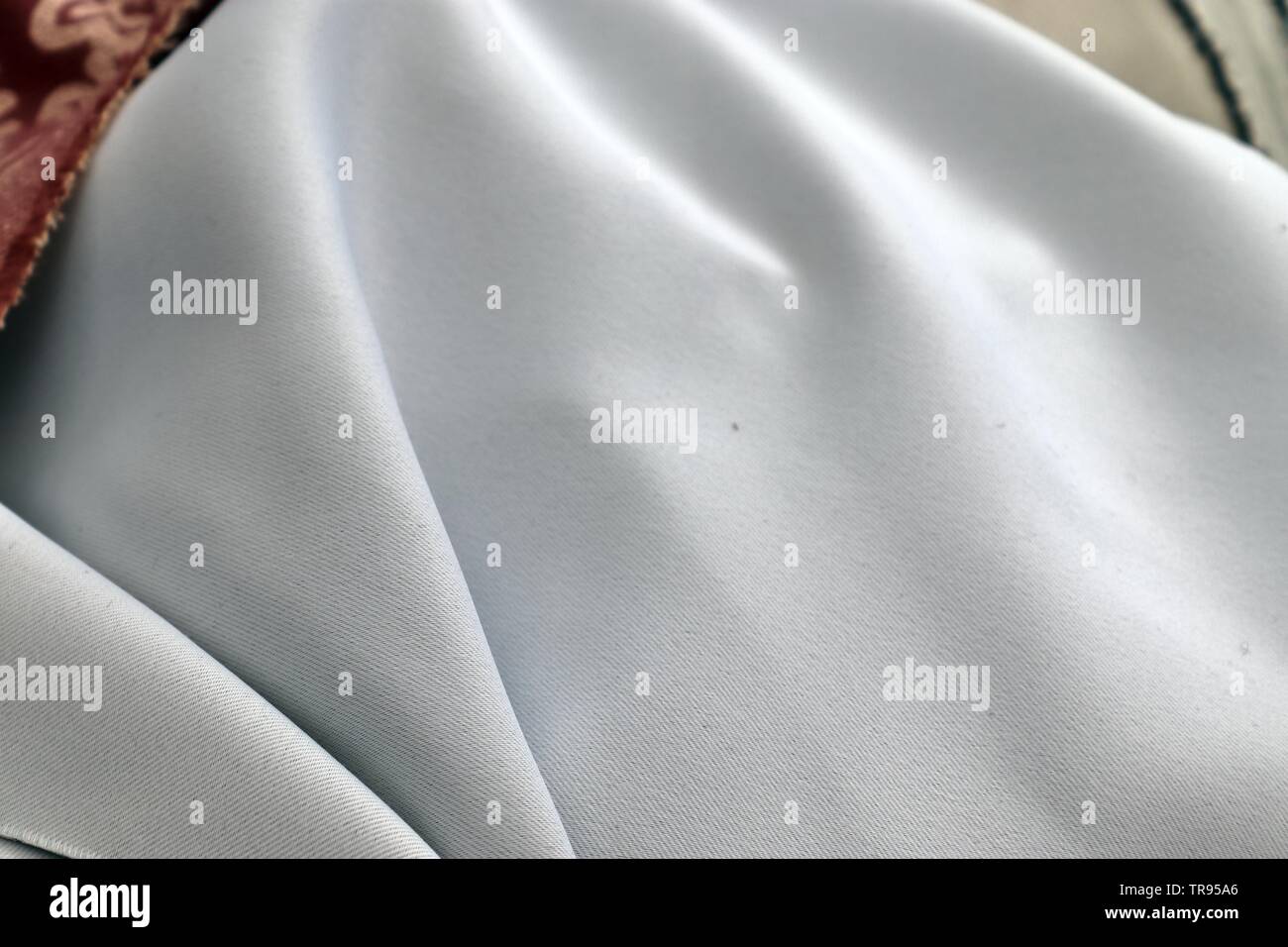 Close up surface of colorful fabrics cloth and textiles being folded ...