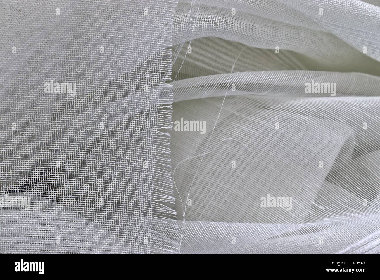 Close up surface of colorful fabrics cloth and textiles being folded ...