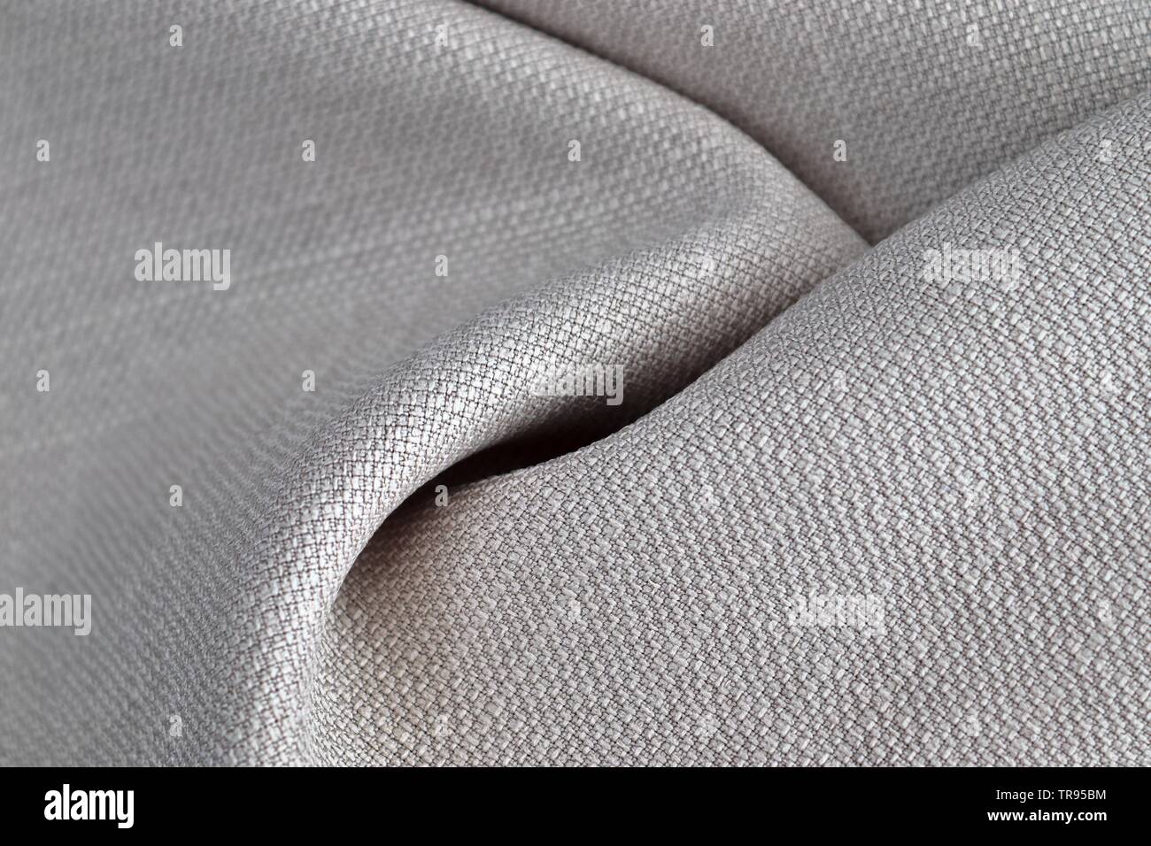 Close up surface of colorful fabrics cloth and textiles being folded ...