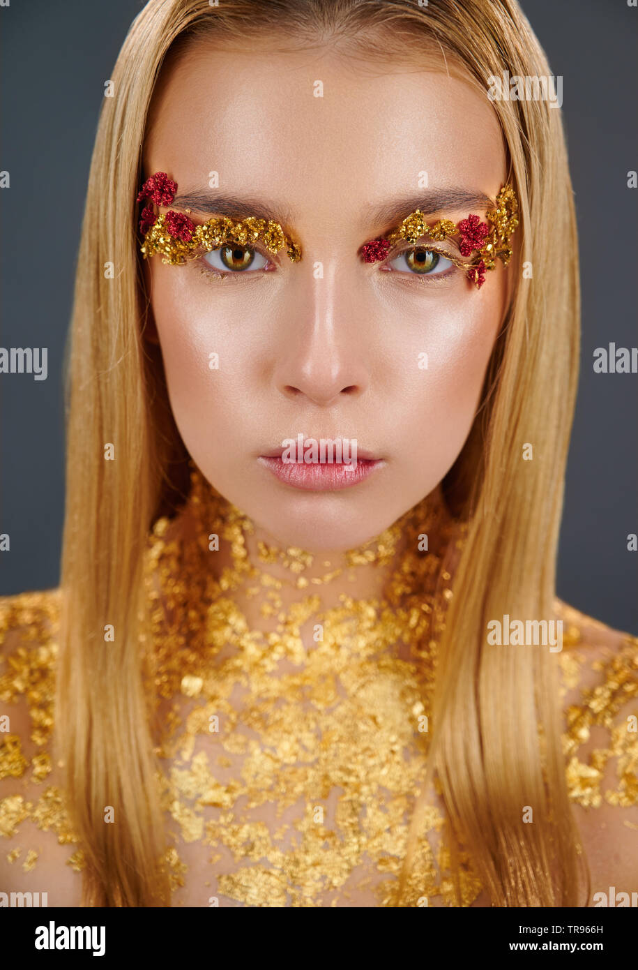 Gilded body. Golden makeup. Portrait of a young woman with makeup ...