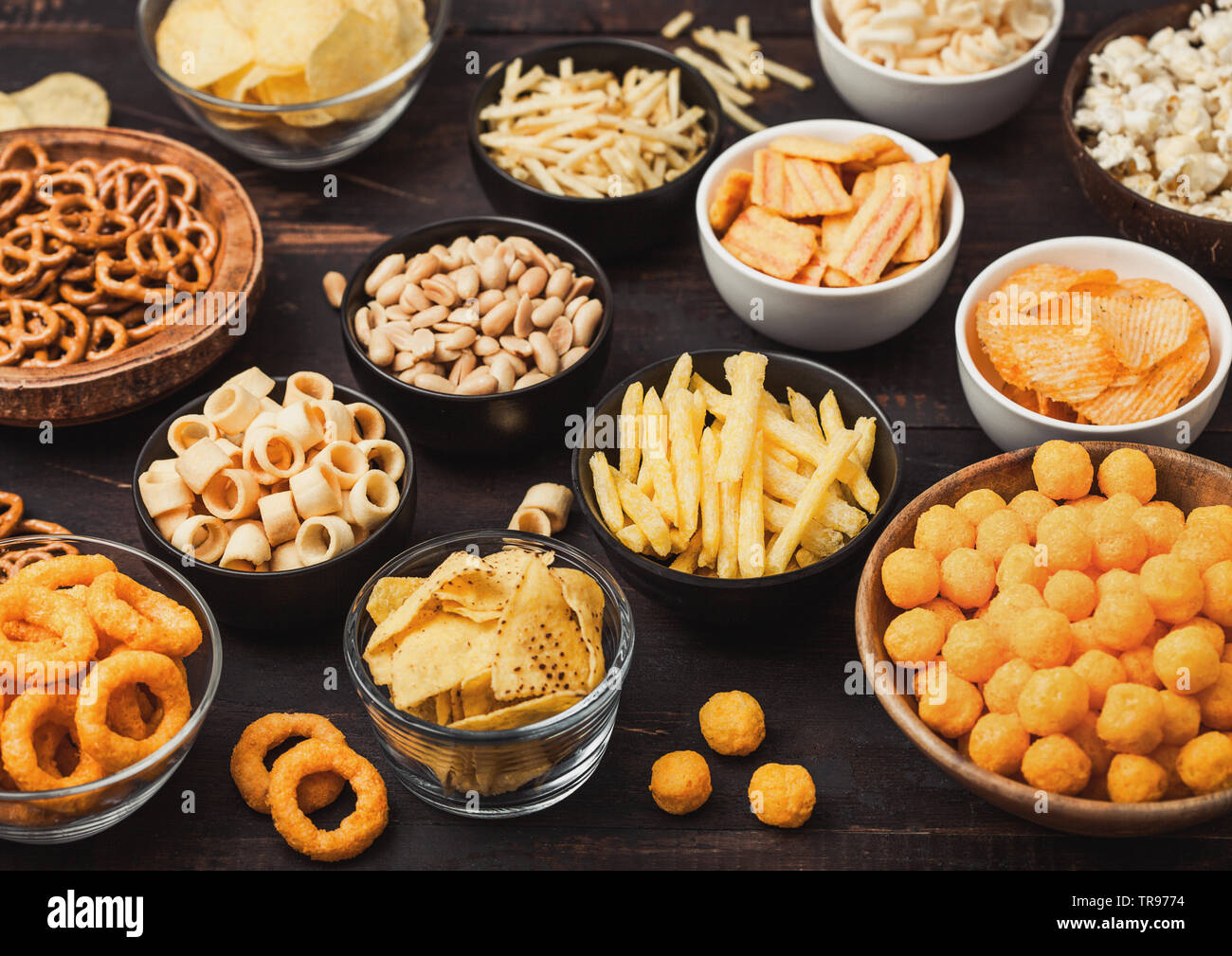 All classic potato snacks with peanuts, popcorn and onion rings and ...