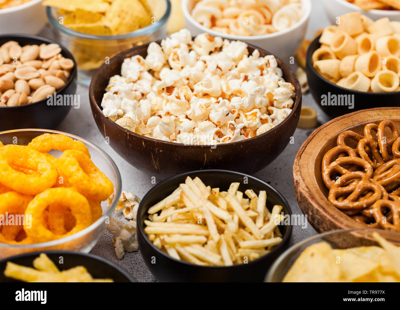 All classic potato snacks with peanuts, popcorn and onion rings and ...