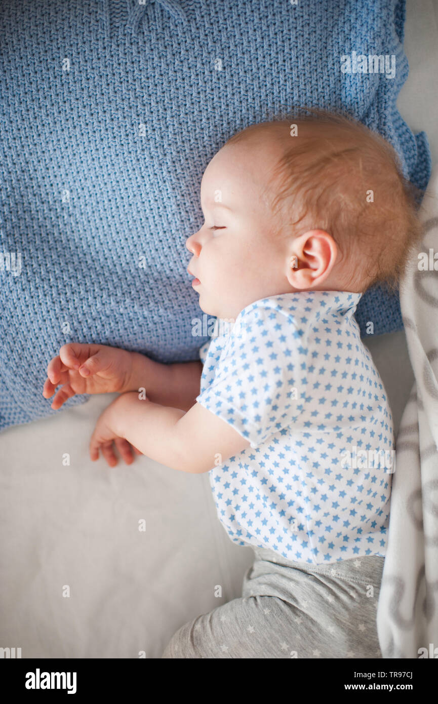 Sleeping baby boy in bed. Top view. Day time sleep. Bedtime. Childhood ...