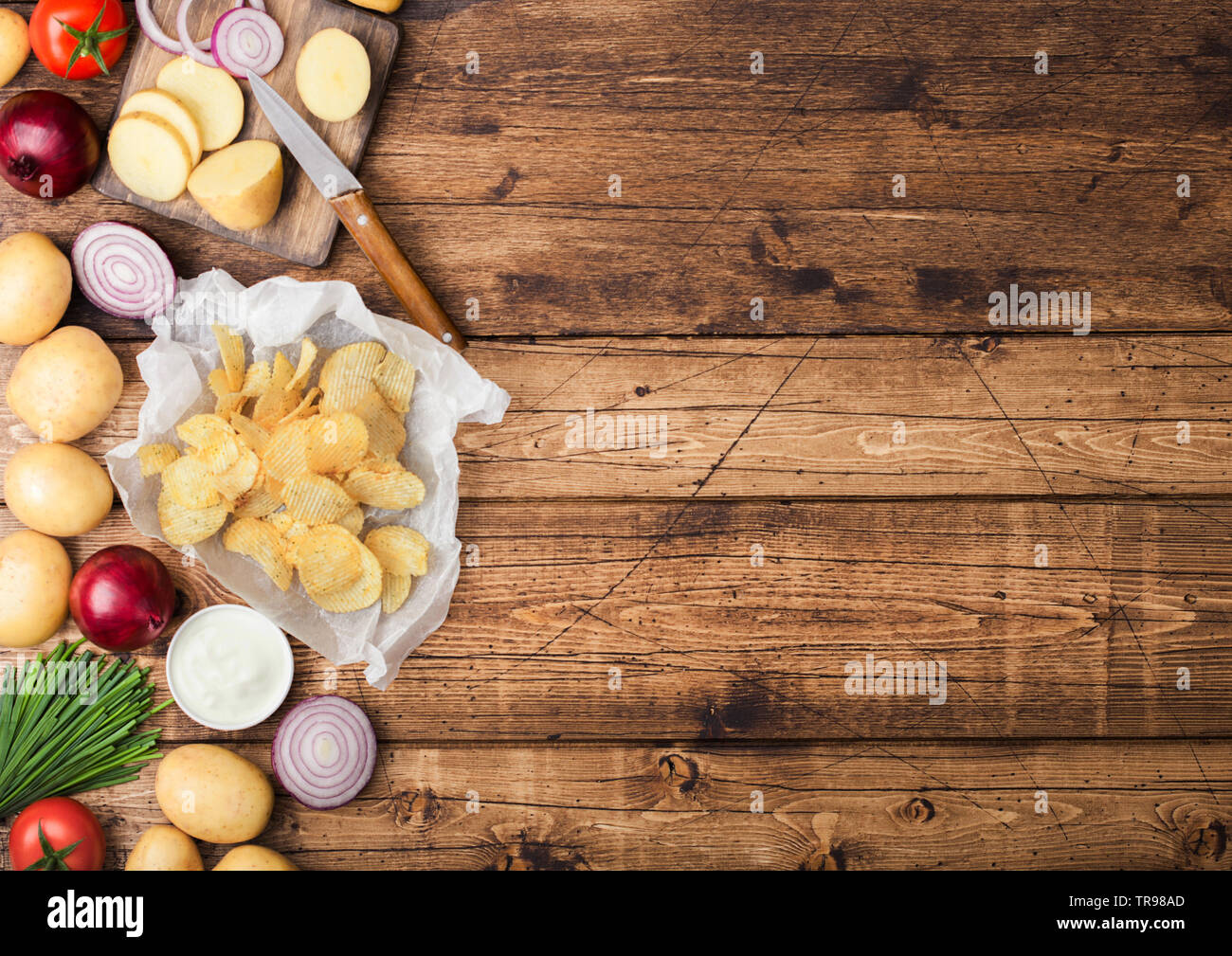 Fresh organic homemade potato crisps chips with sour cream and red ...
