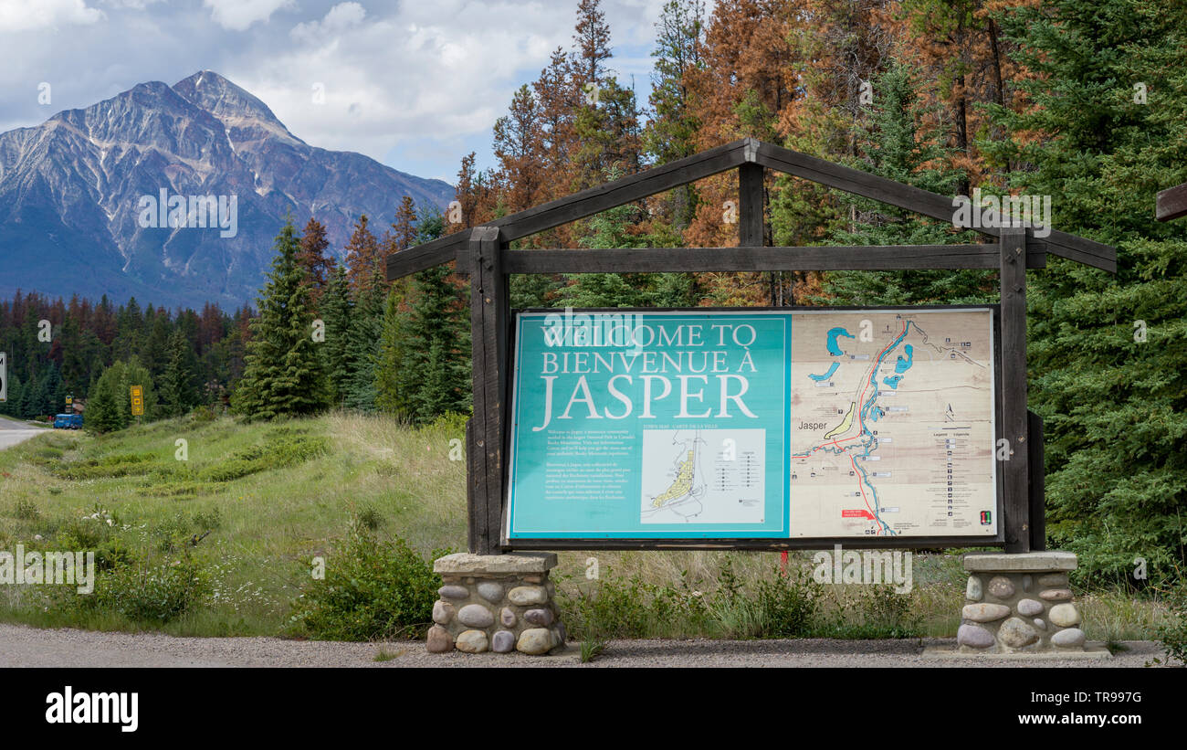 Close-up of welcome sign with mountain in the background, Jasper ...