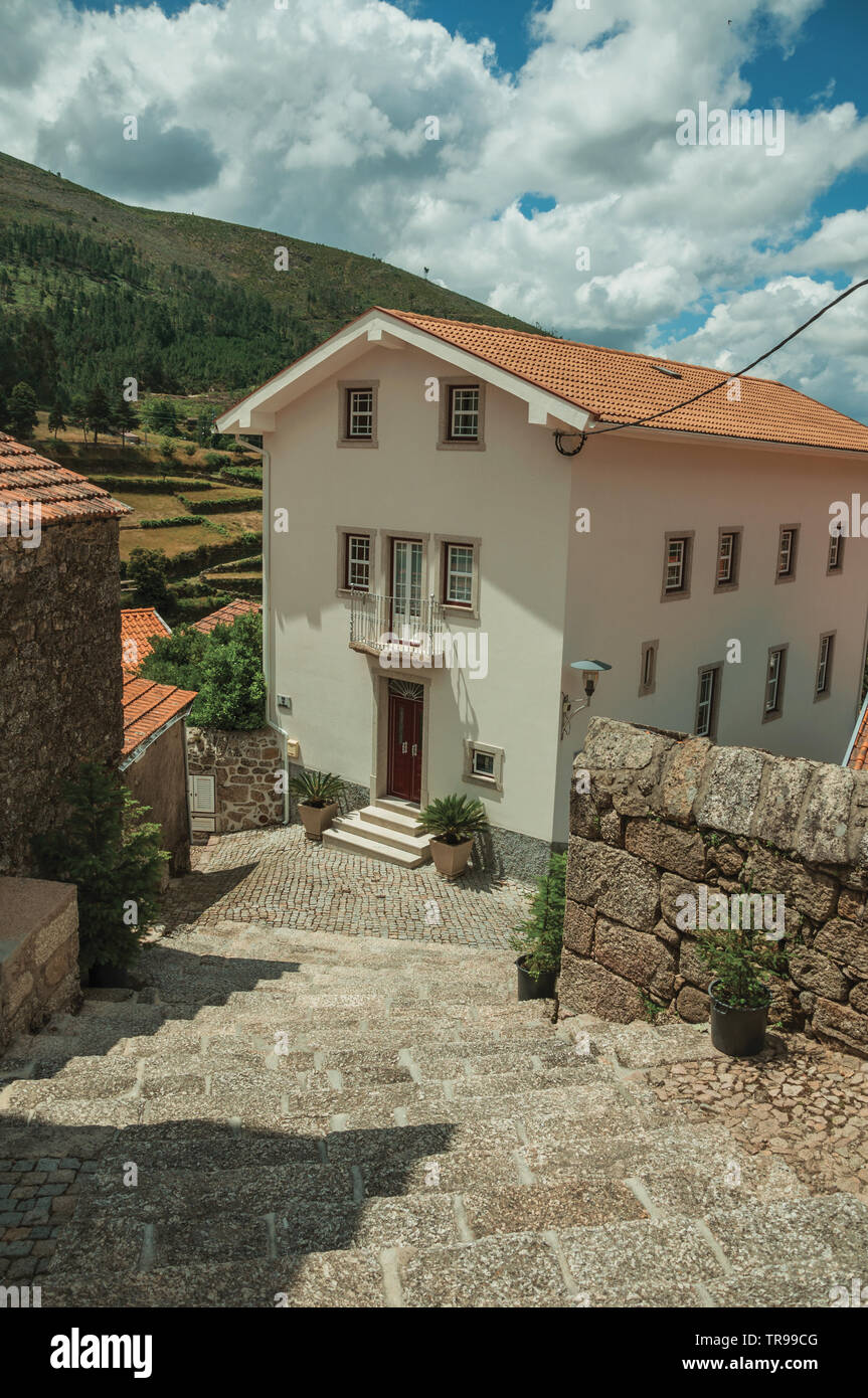 Two-story house at the end of deserted alley on slope with steps at ...