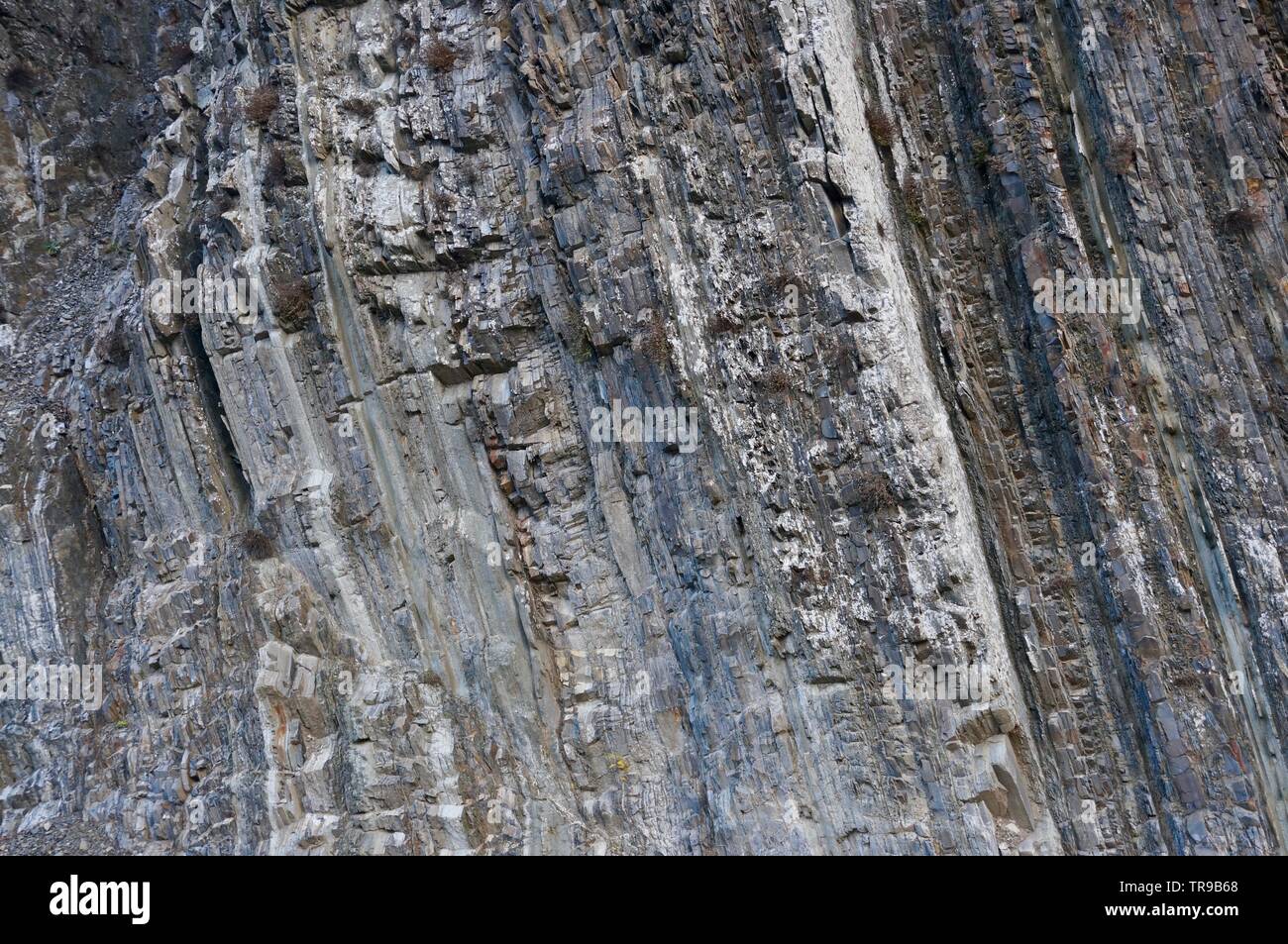 Vertical layers of volcanic rock layers Stock Photo - Alamy