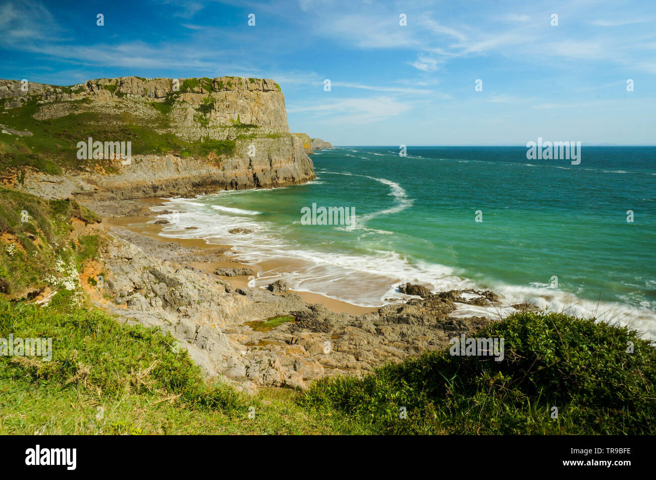 A beautiful rocky cove with cliffs and blue sea Stock Photo - Alamy