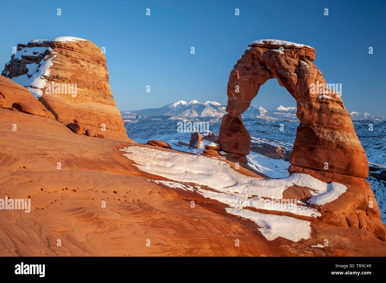 Delicate Arch and La Sal Mountains under snow, Arches National Park ...
