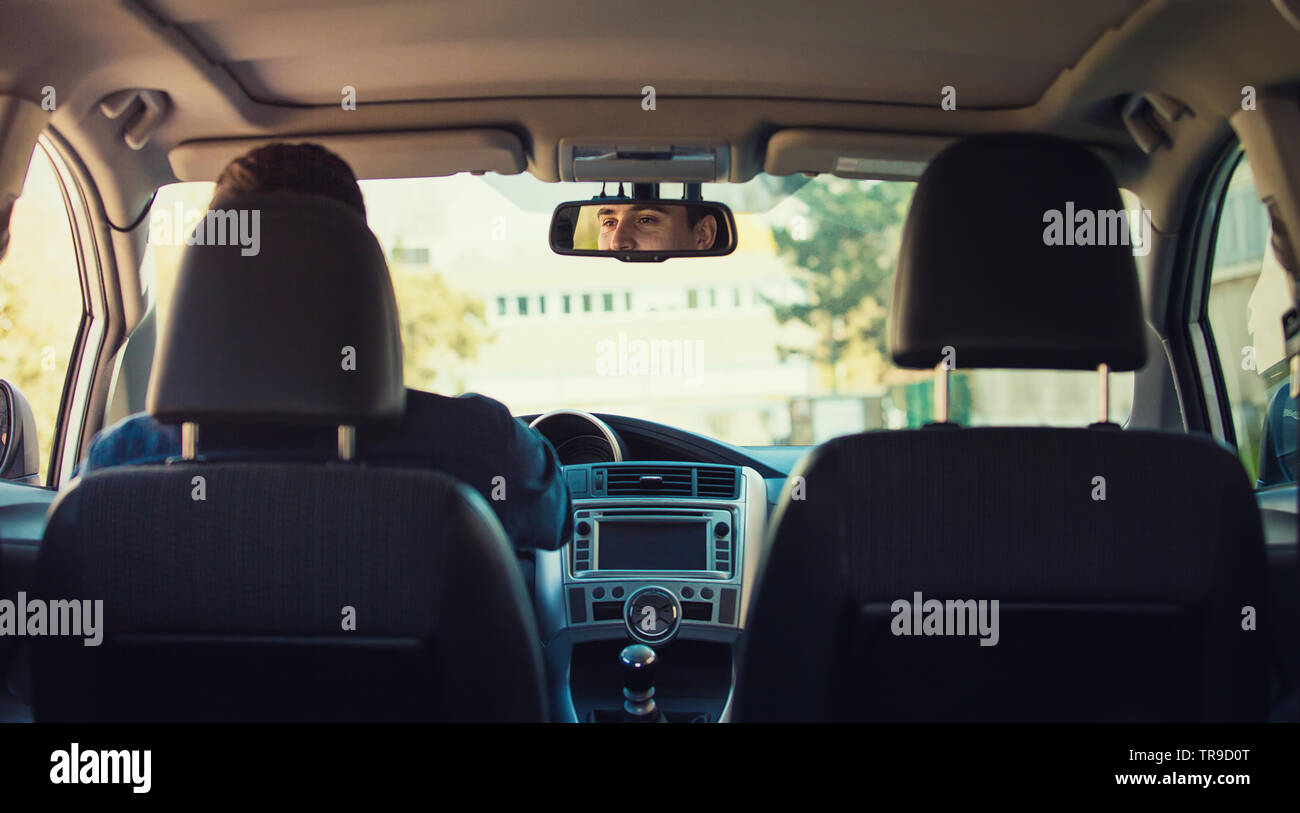Confident and patient man driving his new car with calm face emotion ...