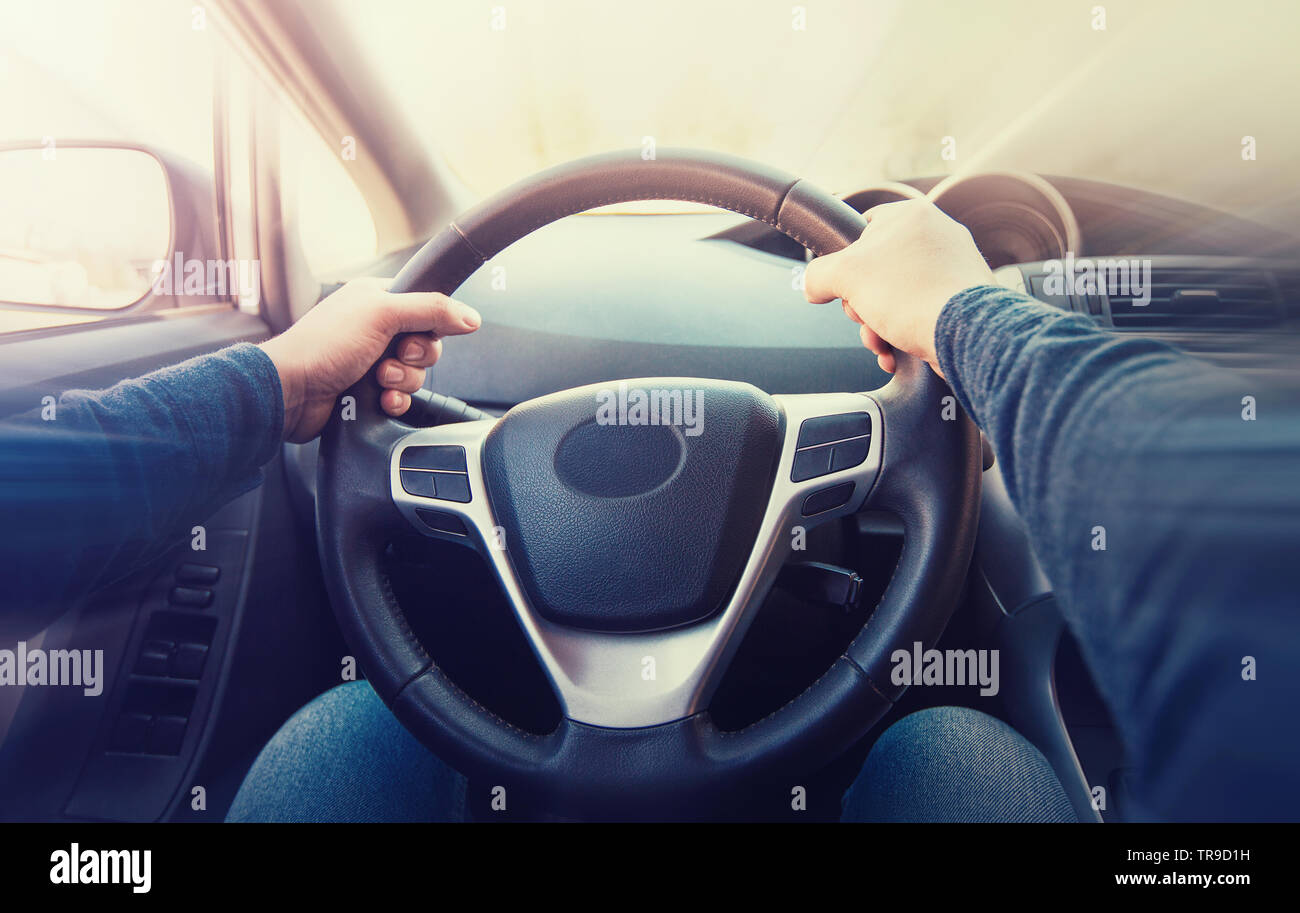 Confident man fast driving his new car. Close up hands of experienced ...
