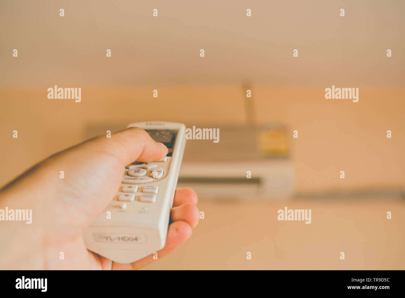 Hand holding remote control air conditioner Stock Photo - Alamy