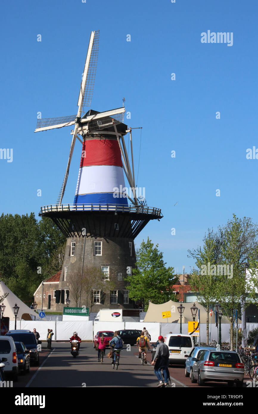 View down busy street in Leiden, Netherlands to Molen De Valk, a ...