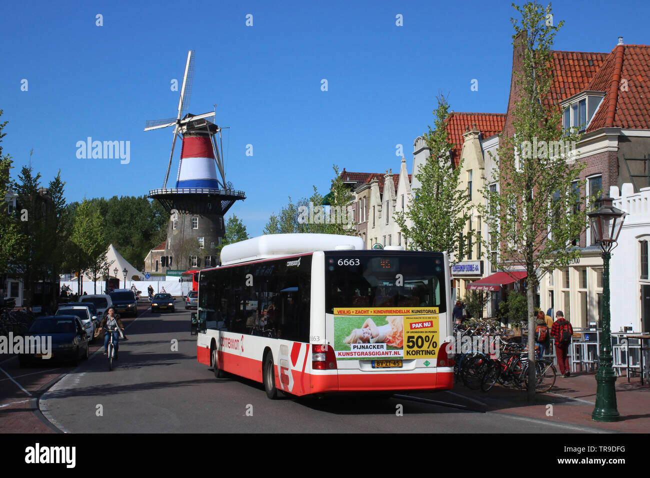 View down busy street in Leiden, Netherlands to Molen De Valk, a ...