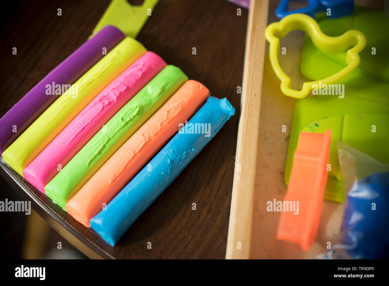 Bars of plasticine in various colors and a yellow mold Stock Photo - Alamy