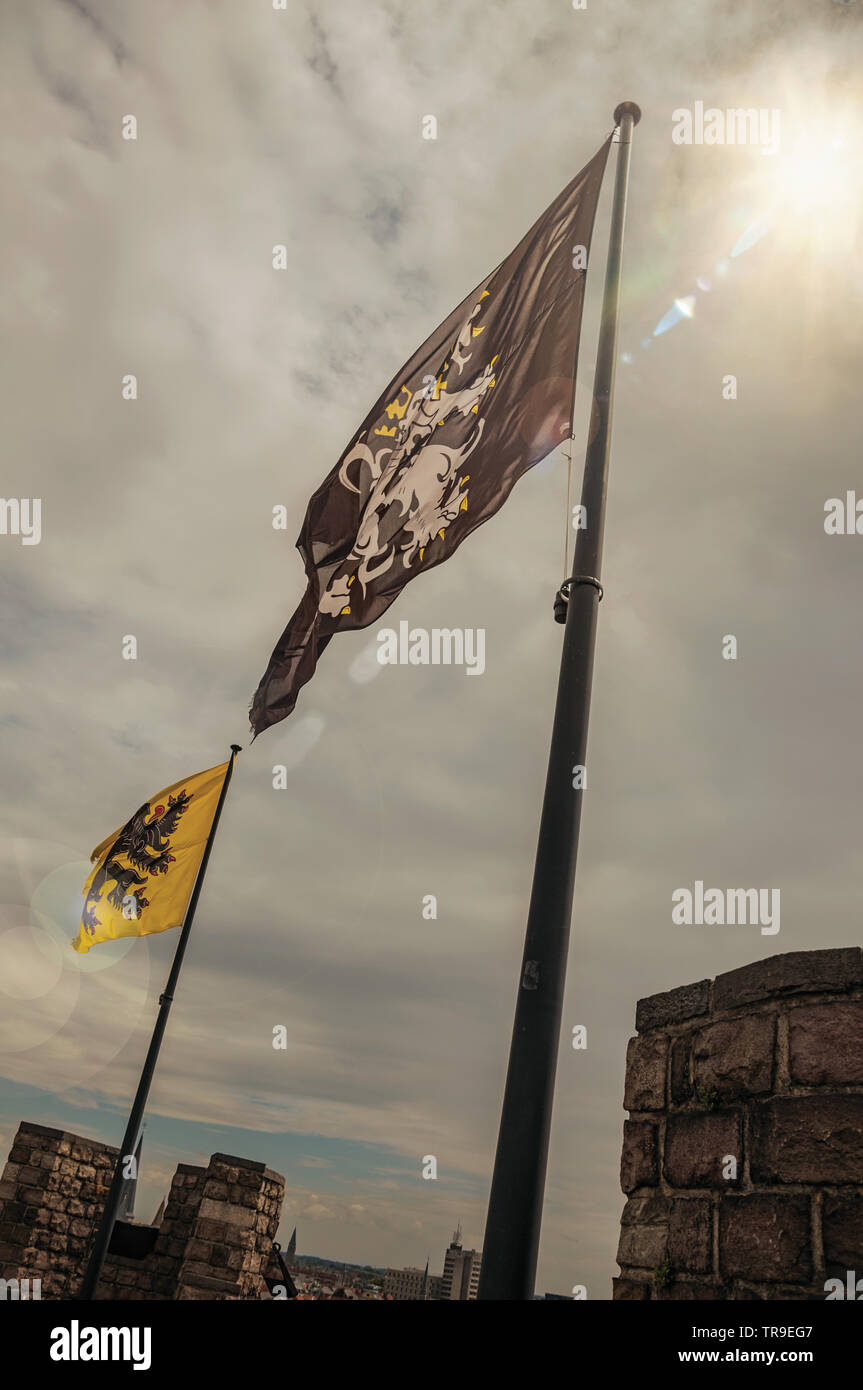 Flags and cloudy sky on the Gravensteen Castle tower in Ghent. City ...