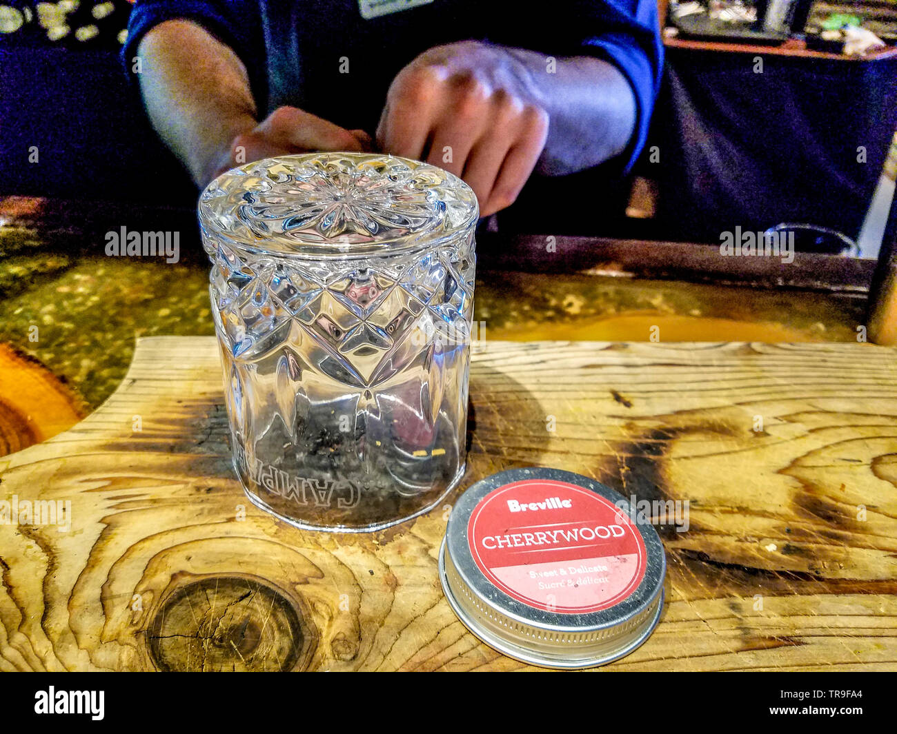 Infusing the glass with wood chip smoke while making the Smoked Old ...