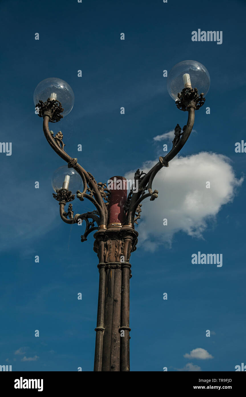 Close-up of cast iron lamp post and blue sunny sky in the City Center ...