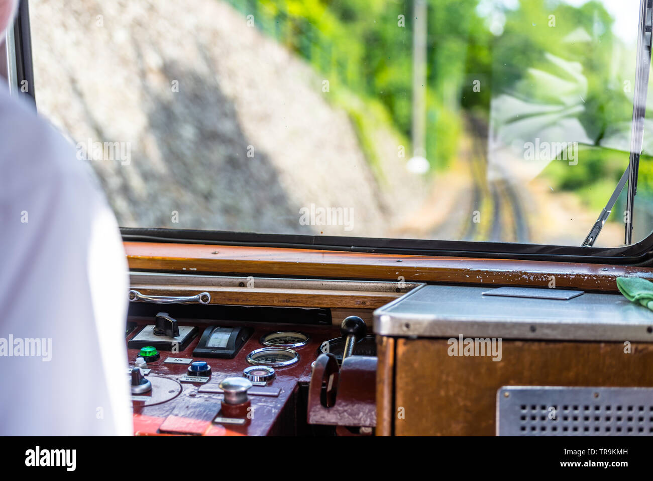 A view from the window of a traveling railroad train, a visible engine ...