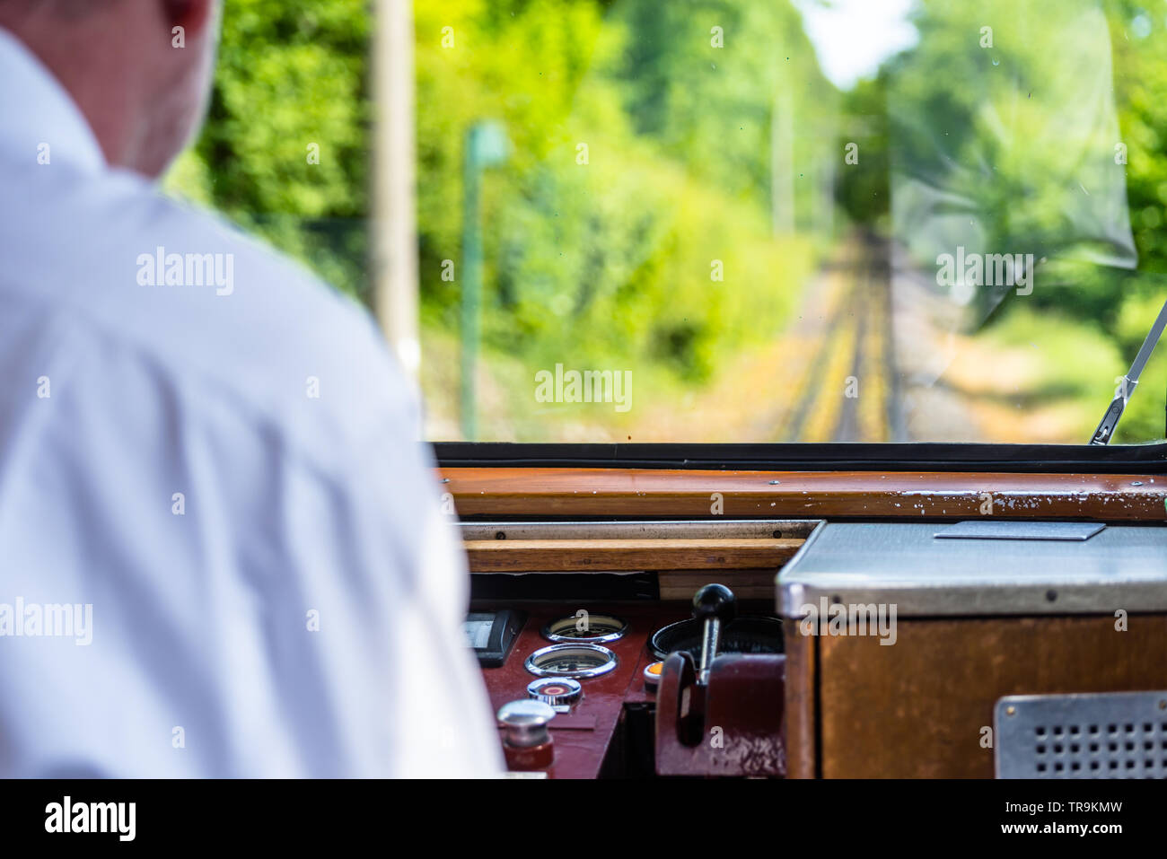 A view from the window of a traveling railroad train, a visible engine ...
