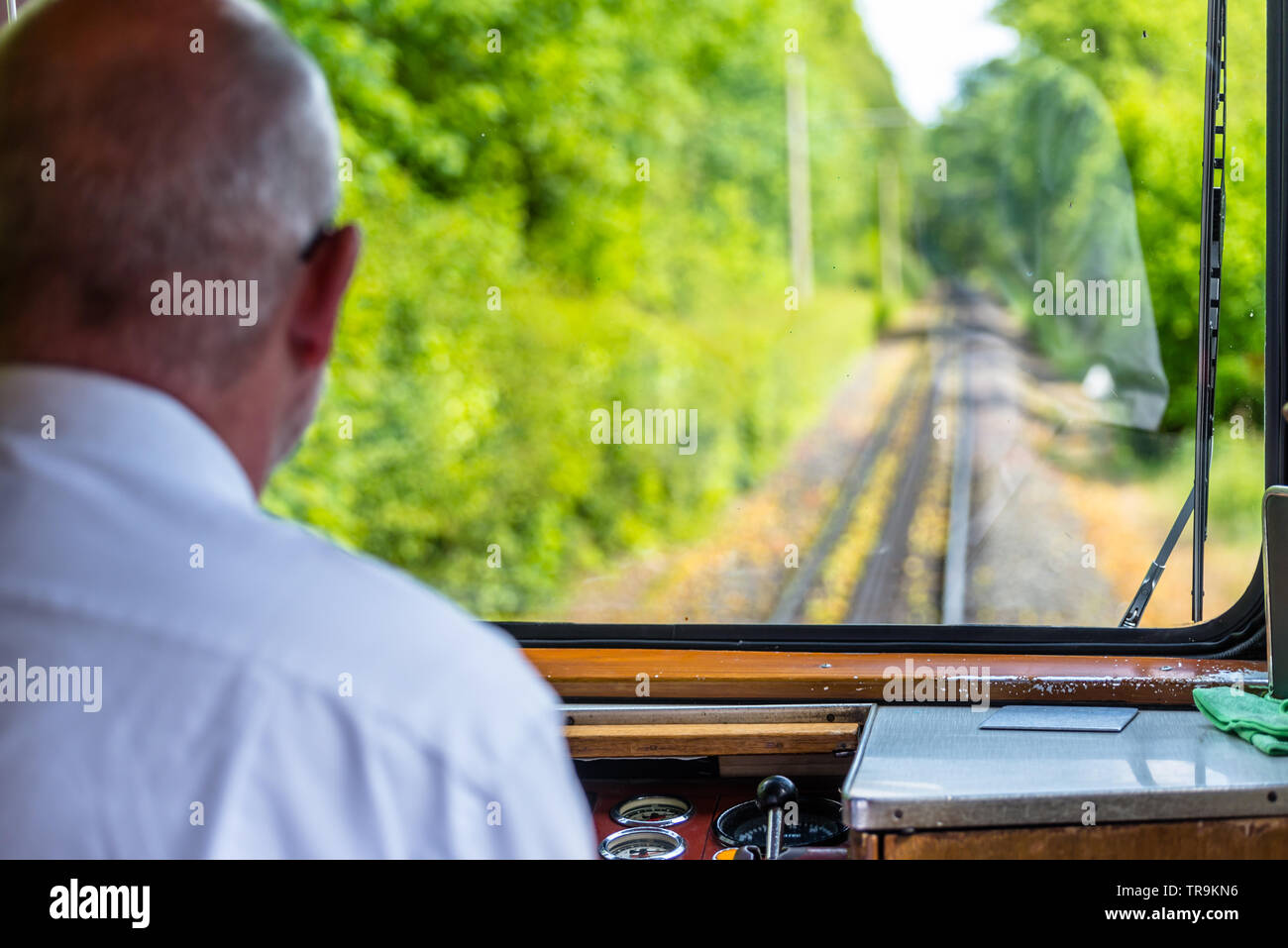 A view from the window of a traveling railroad train, a visible engine ...