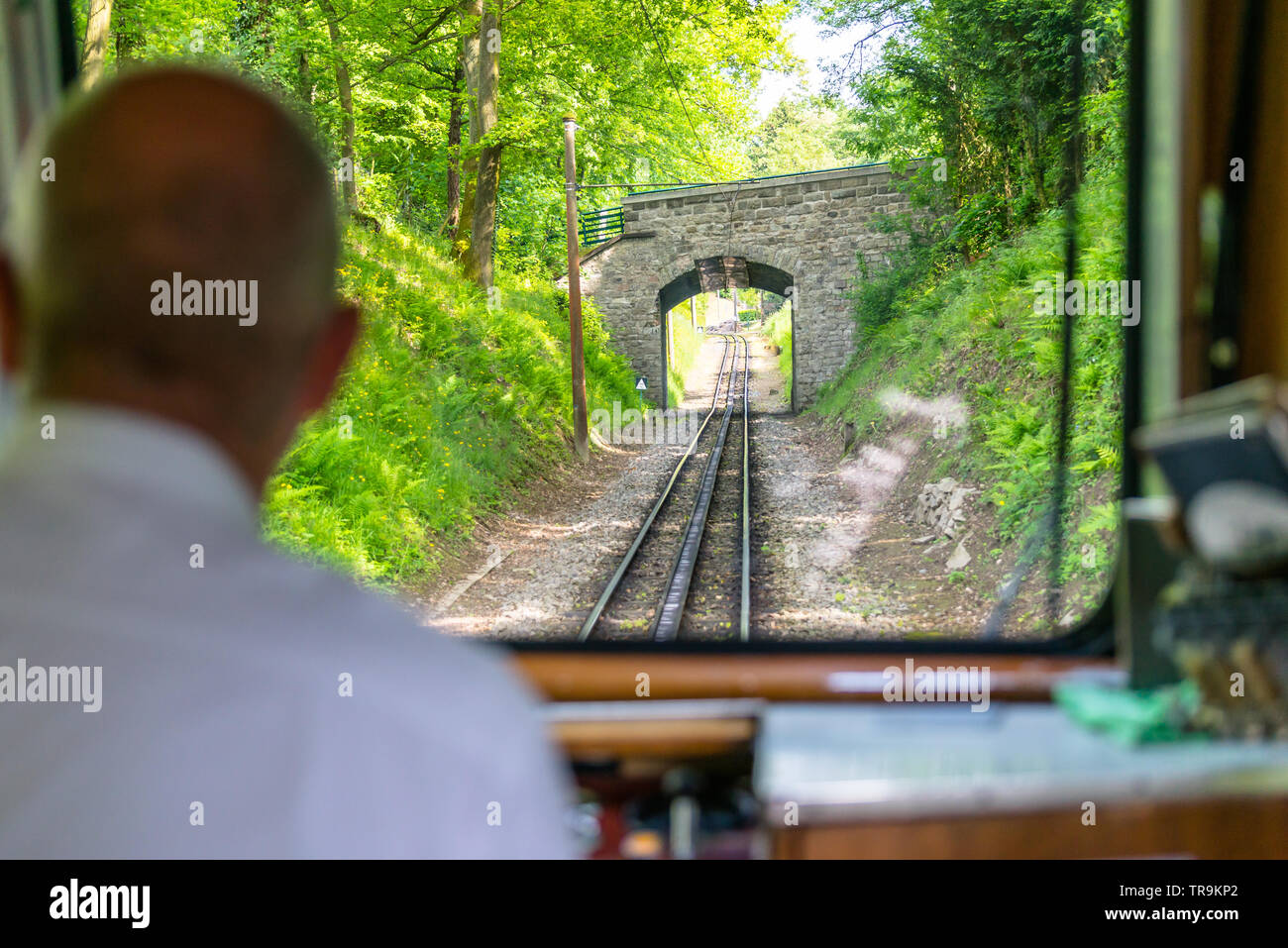 A view from the window of a traveling railroad train, a visible engine ...