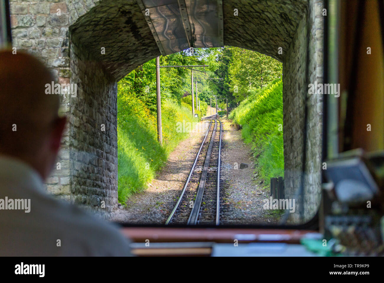 A view from the window of a traveling railroad train, a visible engine ...
