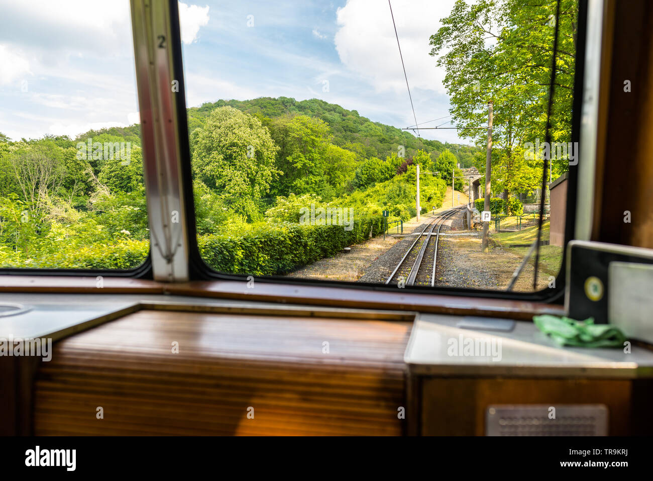 A view from the window of a moving train, visible tracks, trees and ...